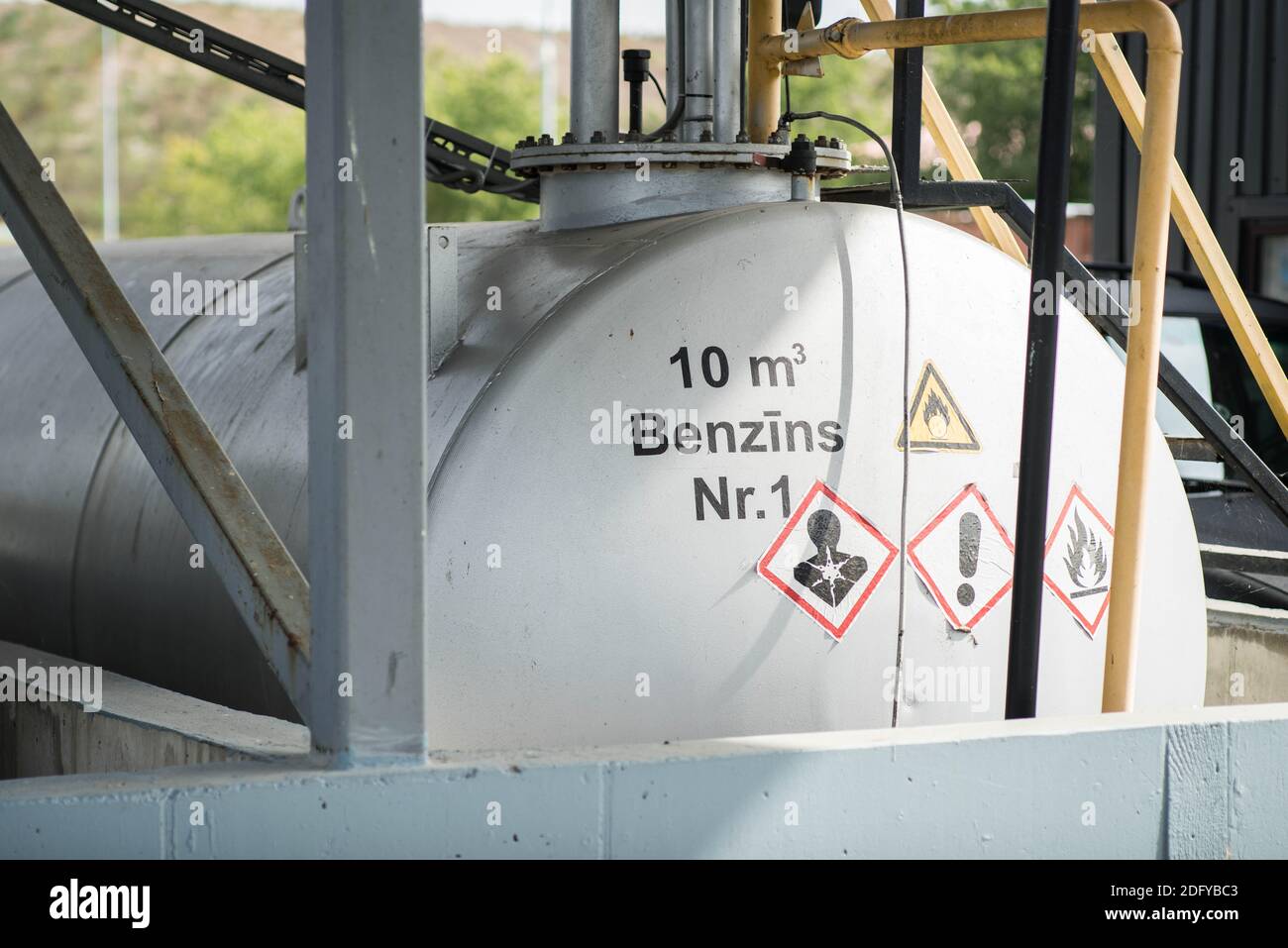Huge fuel storage tank with danger symbols at gas station Stock Photo ...