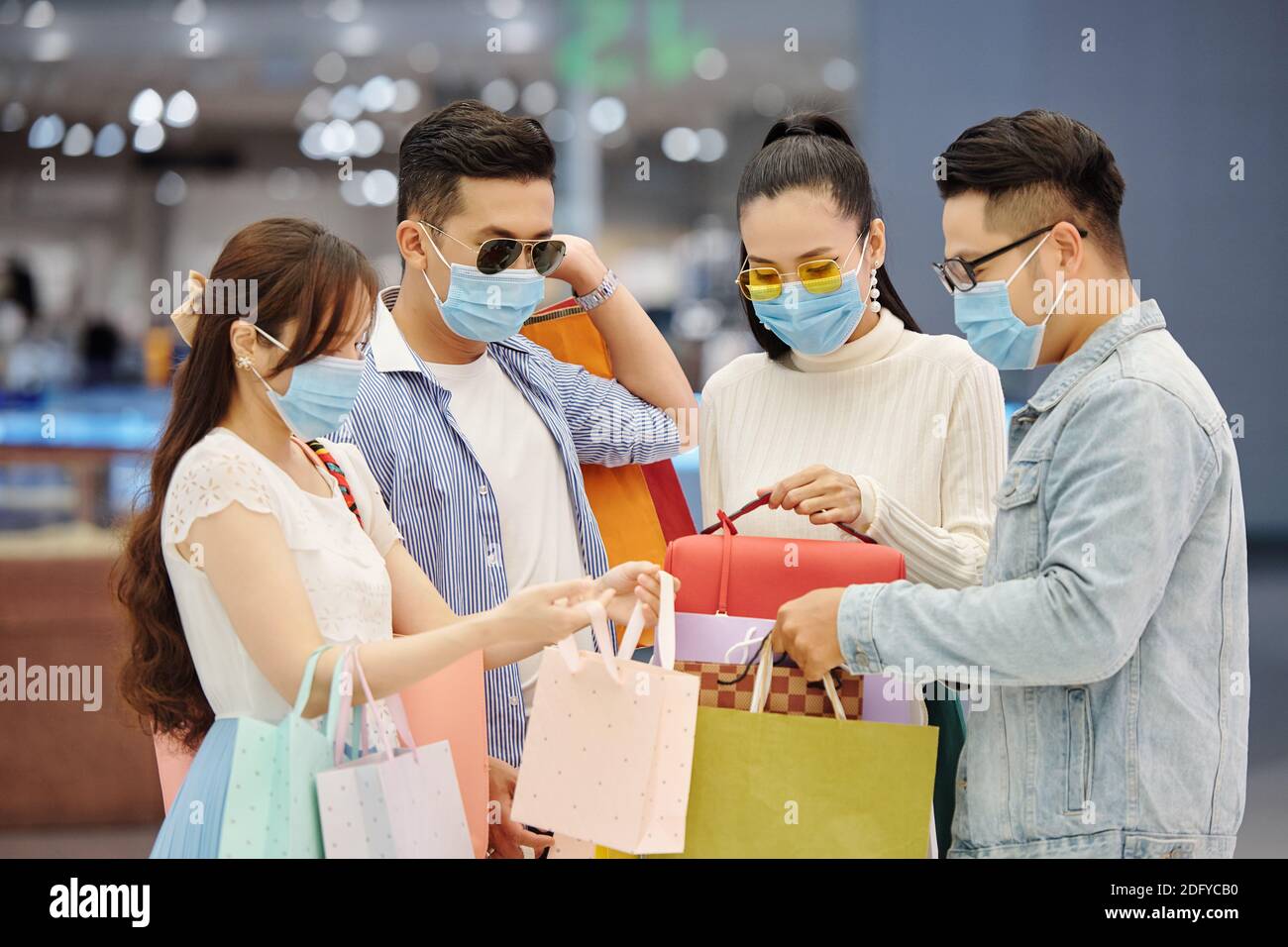 Friends sharing purchases Stock Photo - Alamy