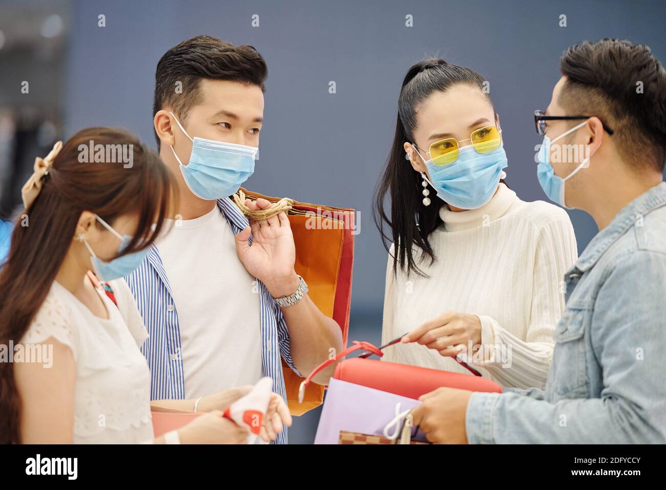 Group of friends with paper bag Stock Photo - Alamy