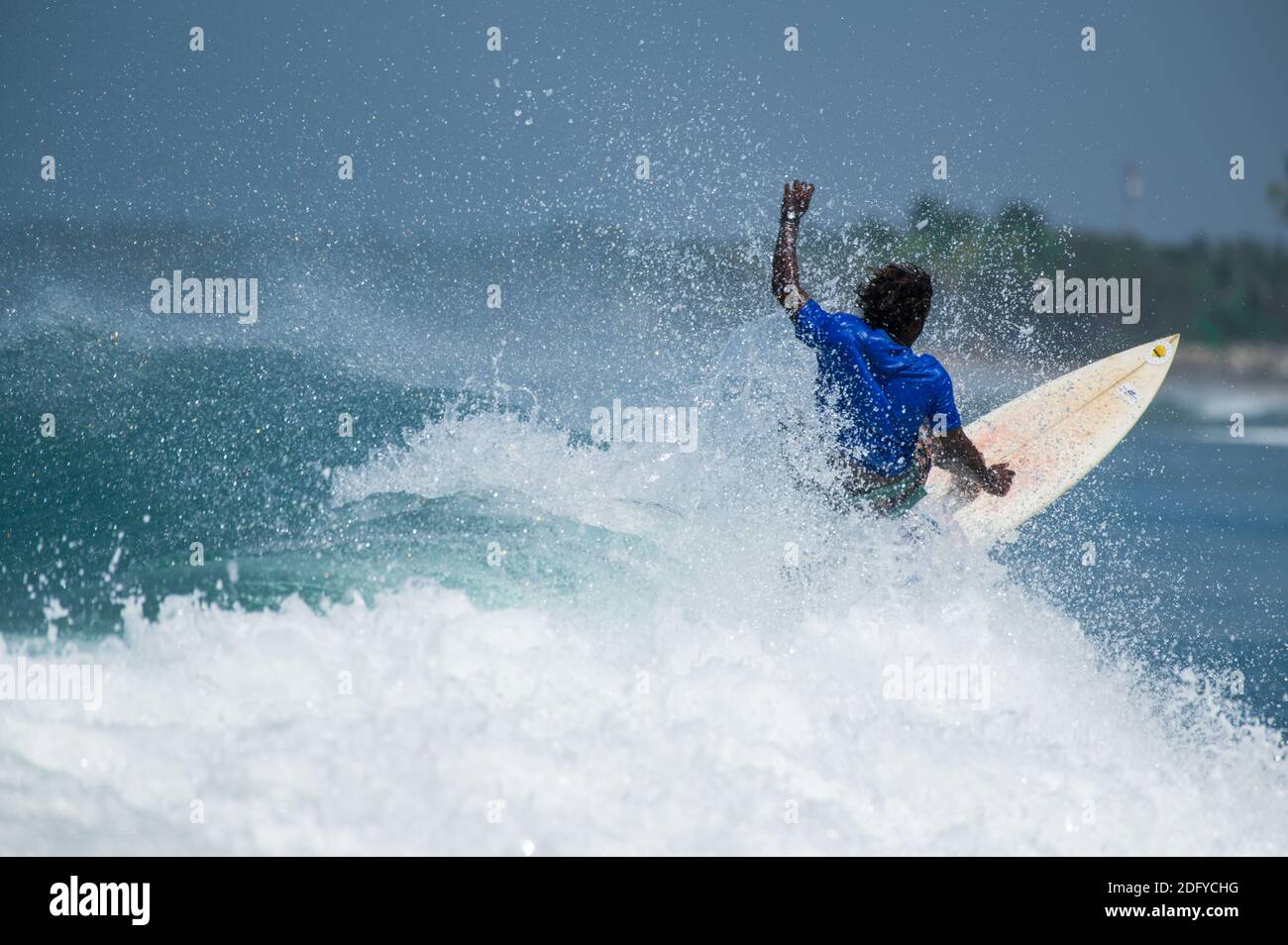 VARKALA, INDIA - Mar 14, 2020: An Indian Male falling off of his Surf ...