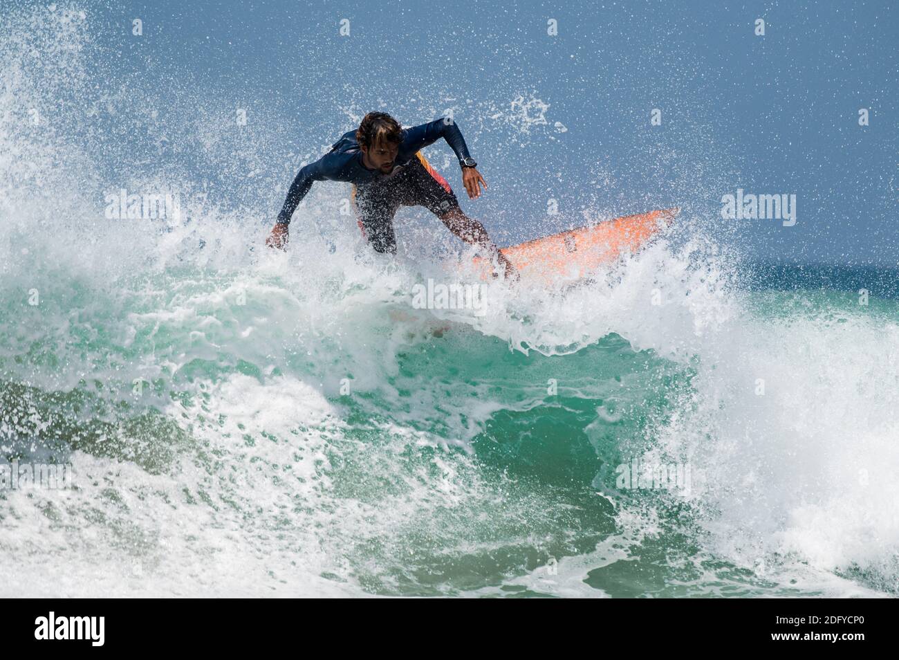 VARKALA, INDIA - Mar 14, 2020: An Indian Male Surfer on his Surf Board ...