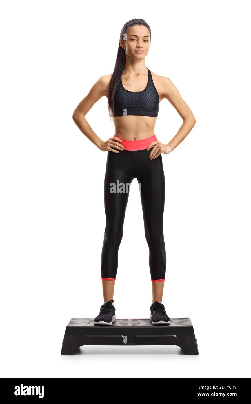 Full length portrait of a slim woman standing on a step aerobic ...