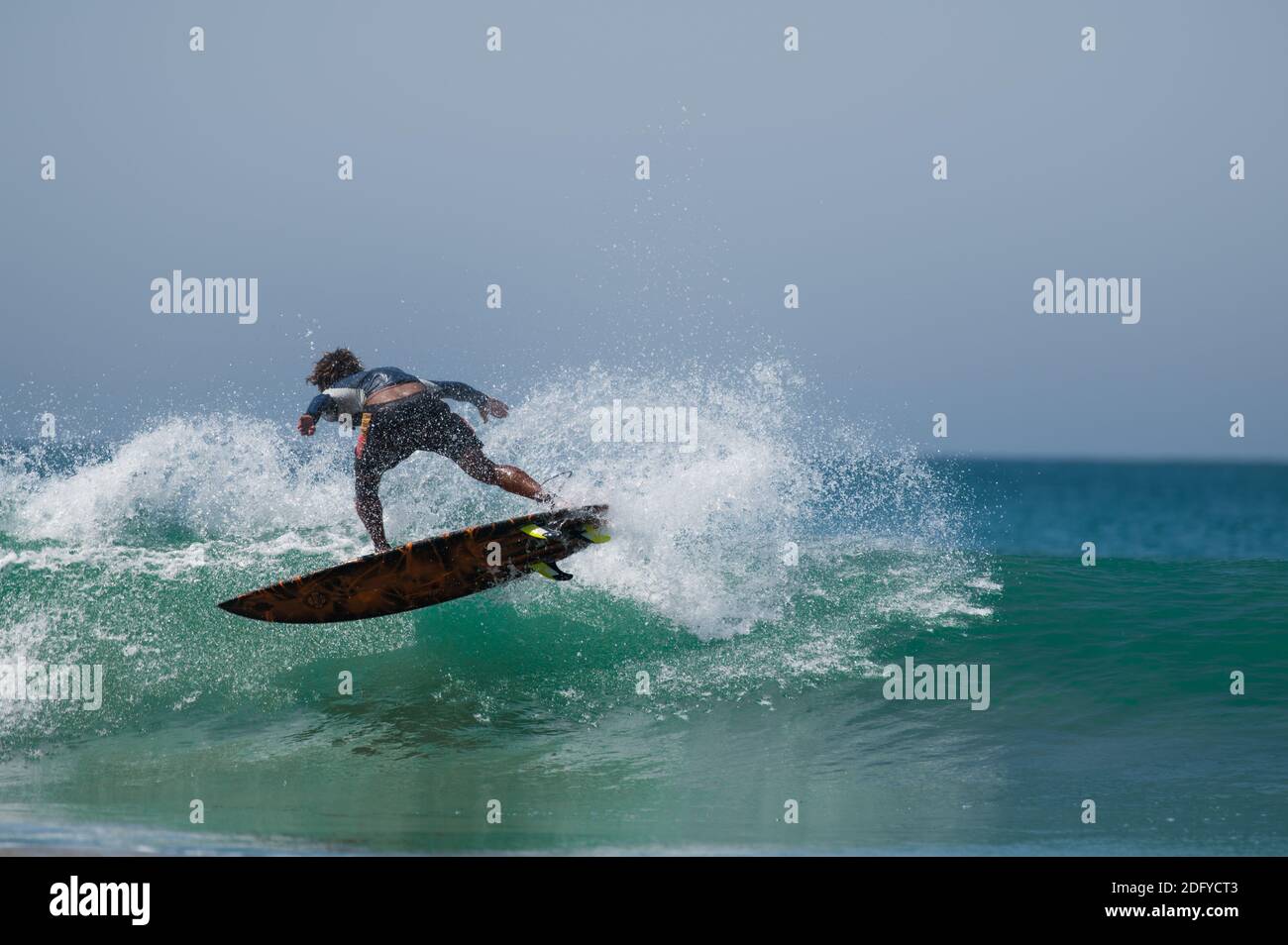 VARKALA, INDIA - Mar 14, 2020: An Indian Male Surfer on his Surf Board ...