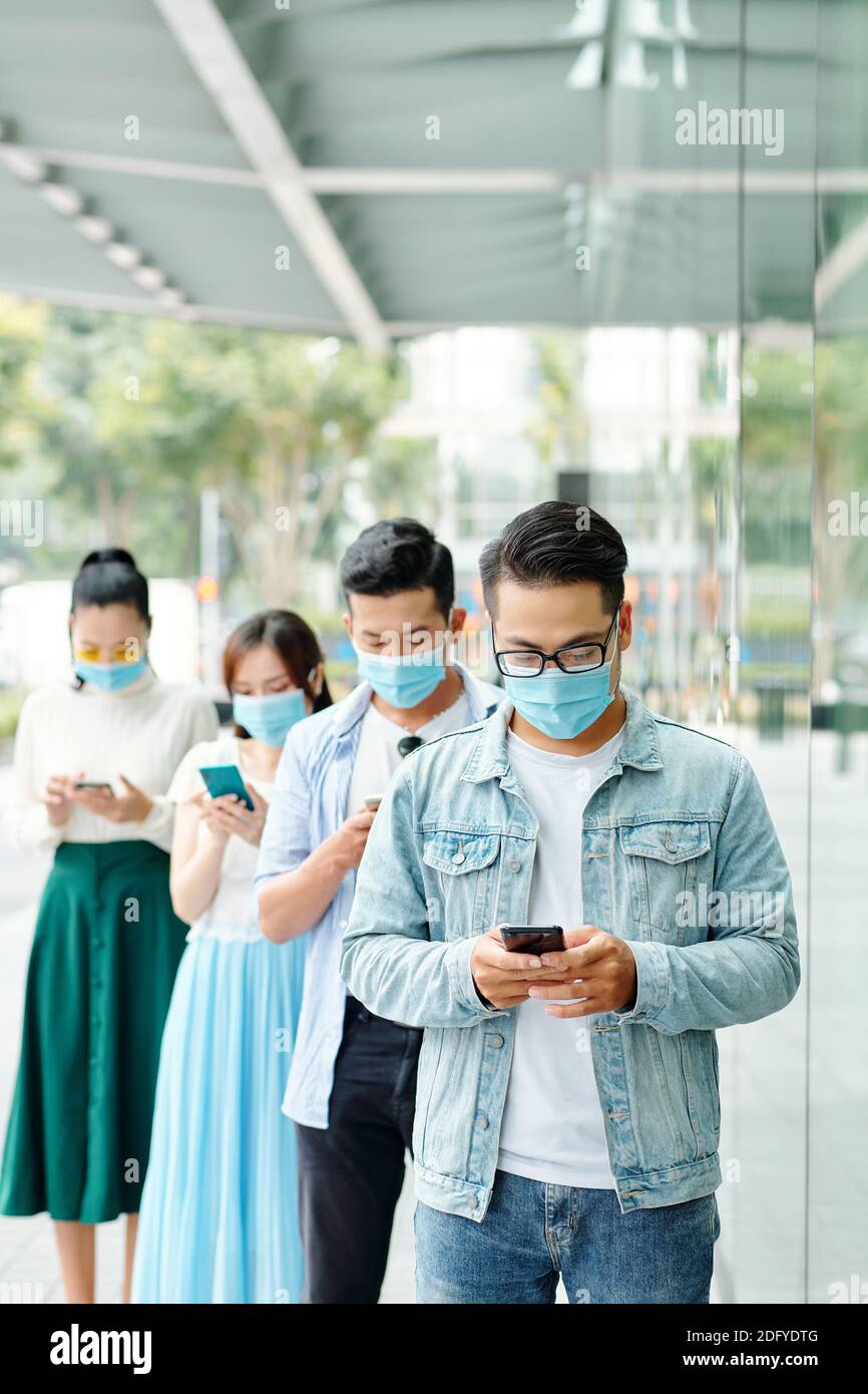 Young people checking phones Stock Photo - Alamy
