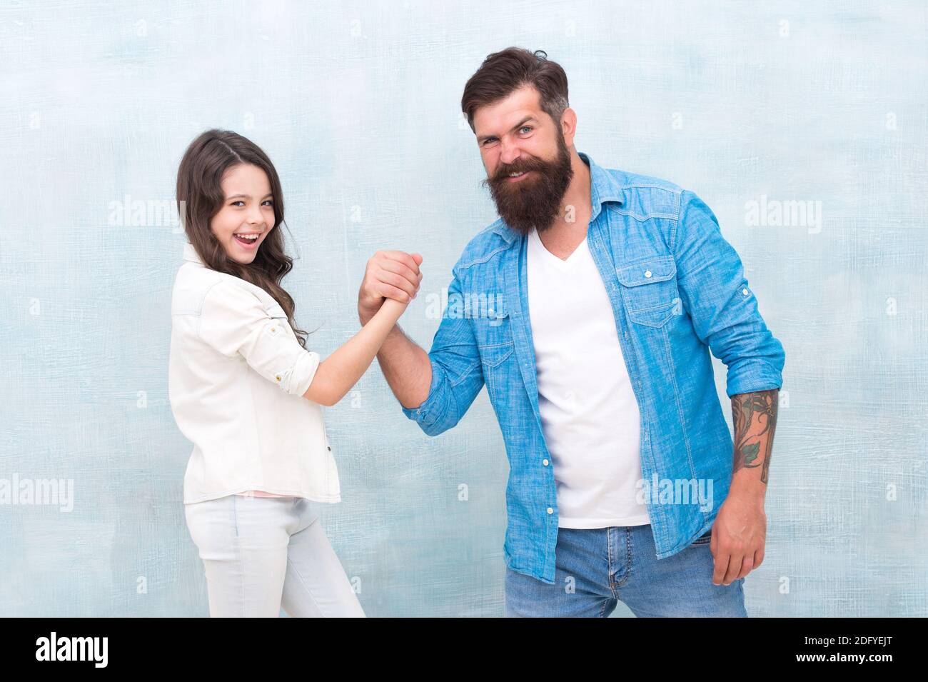Who is stronger. Father and child compete in arm wrestling. Strength ...