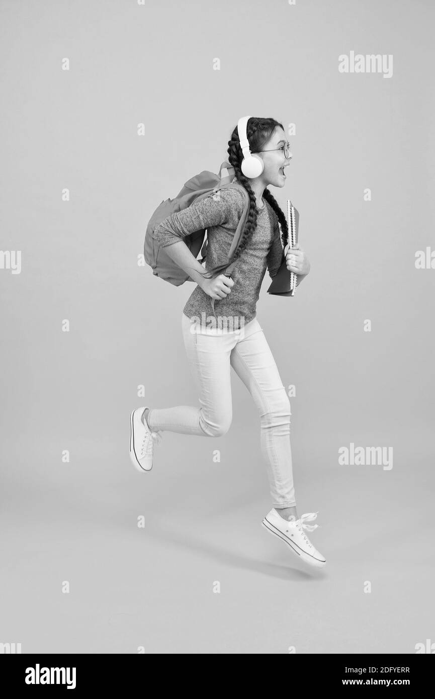 Full of energy. Energetic child run to school. Happy girl in motion ...