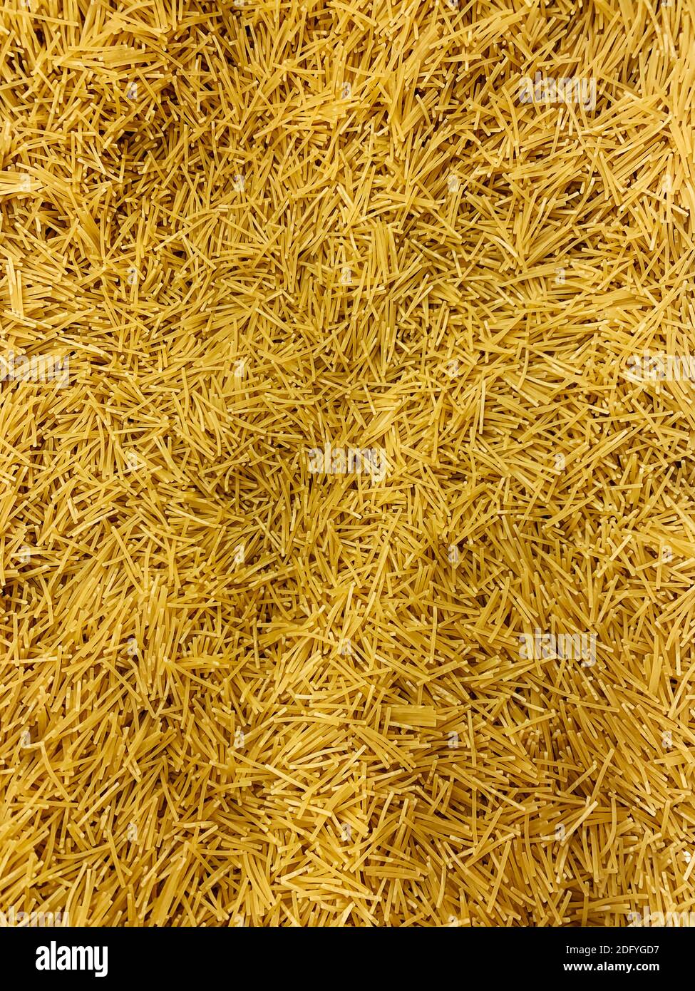 lots of pasta noodles for cooking as a background Stock Photo - Alamy