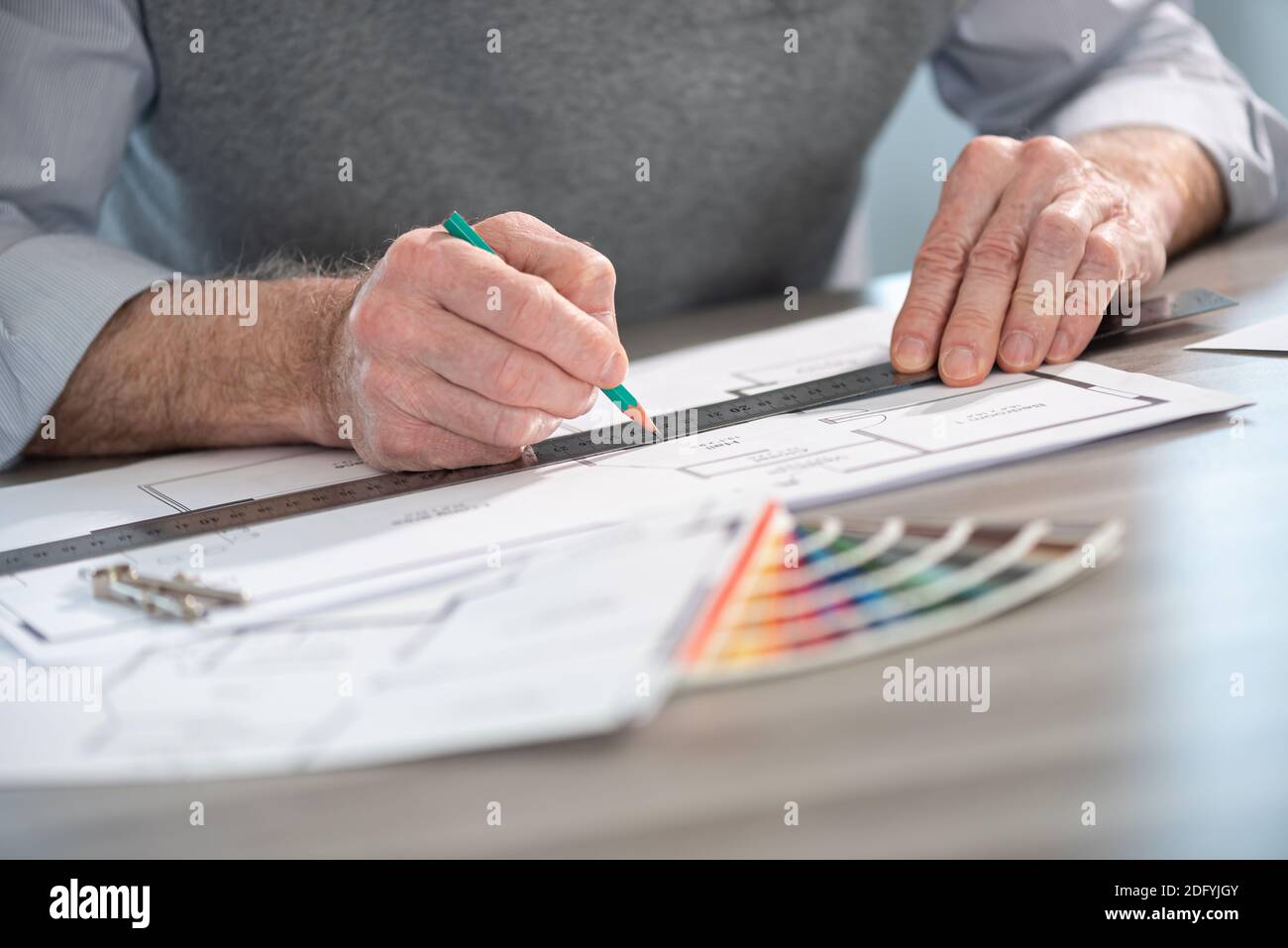 Architect working on a project and using a ruler Stock Photo - Alamy