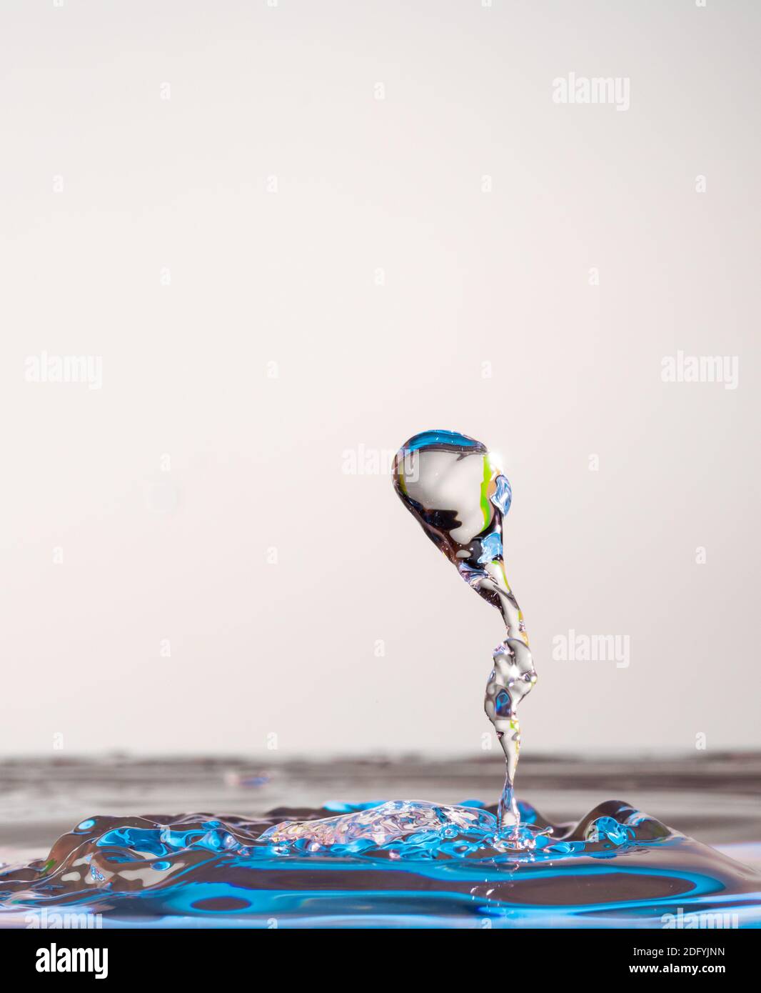 Water drop falling and impacting body of water. macro photo Stock Photo ...
