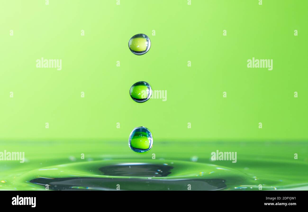 Water drop falling and impacting body of water. macro photo Stock Photo ...