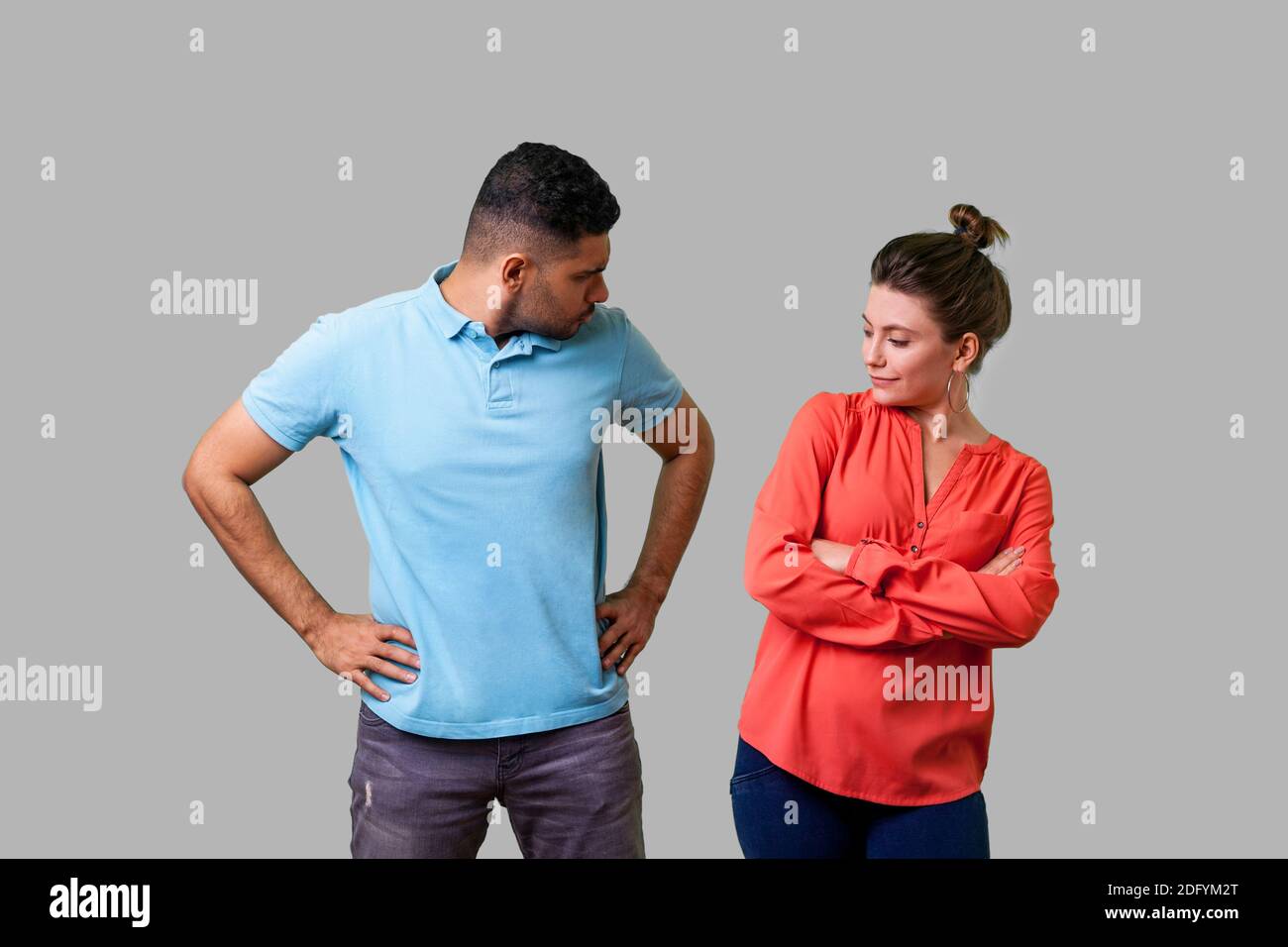 Portrait of resentful dissatisfied couple in casual wear standing ...