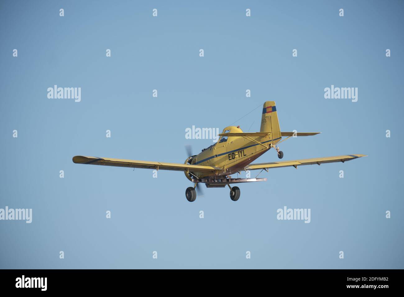 A vintage single-engine aircraft with a propeller flying in a perfectly ...