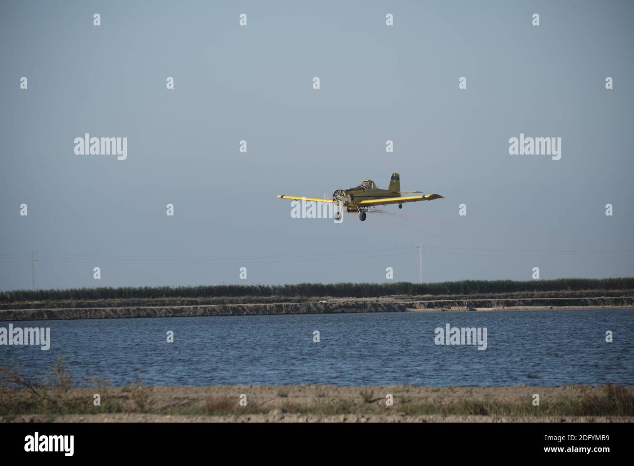 A vintage single-engine aircraft with a propeller flying in a perfectly ...