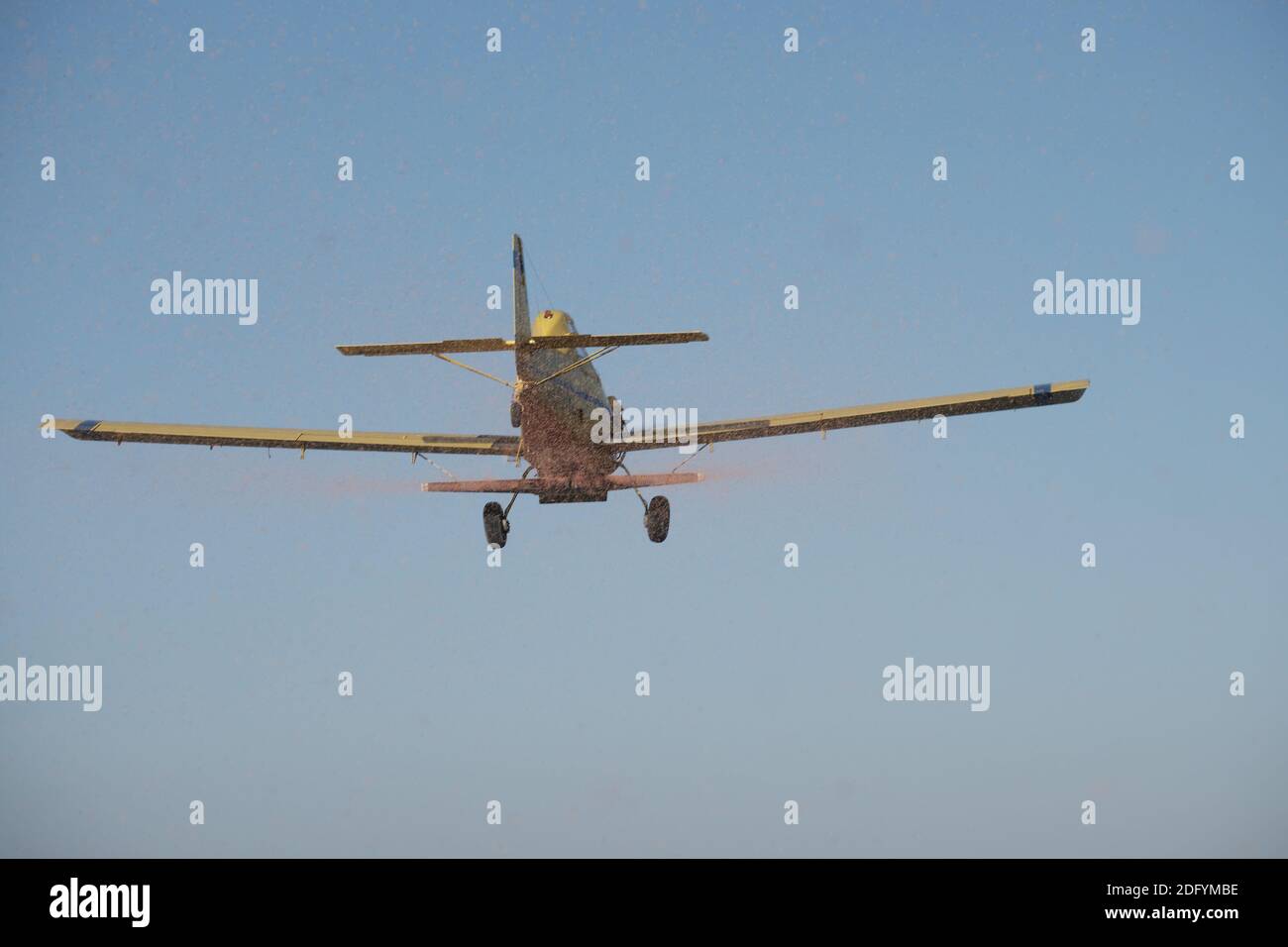 A vintage single-engine aircraft with a propeller flying in a perfectly ...