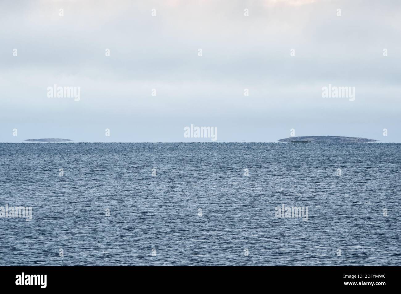 Mirage on the White sea. Islands hover above the water on the horizon ...