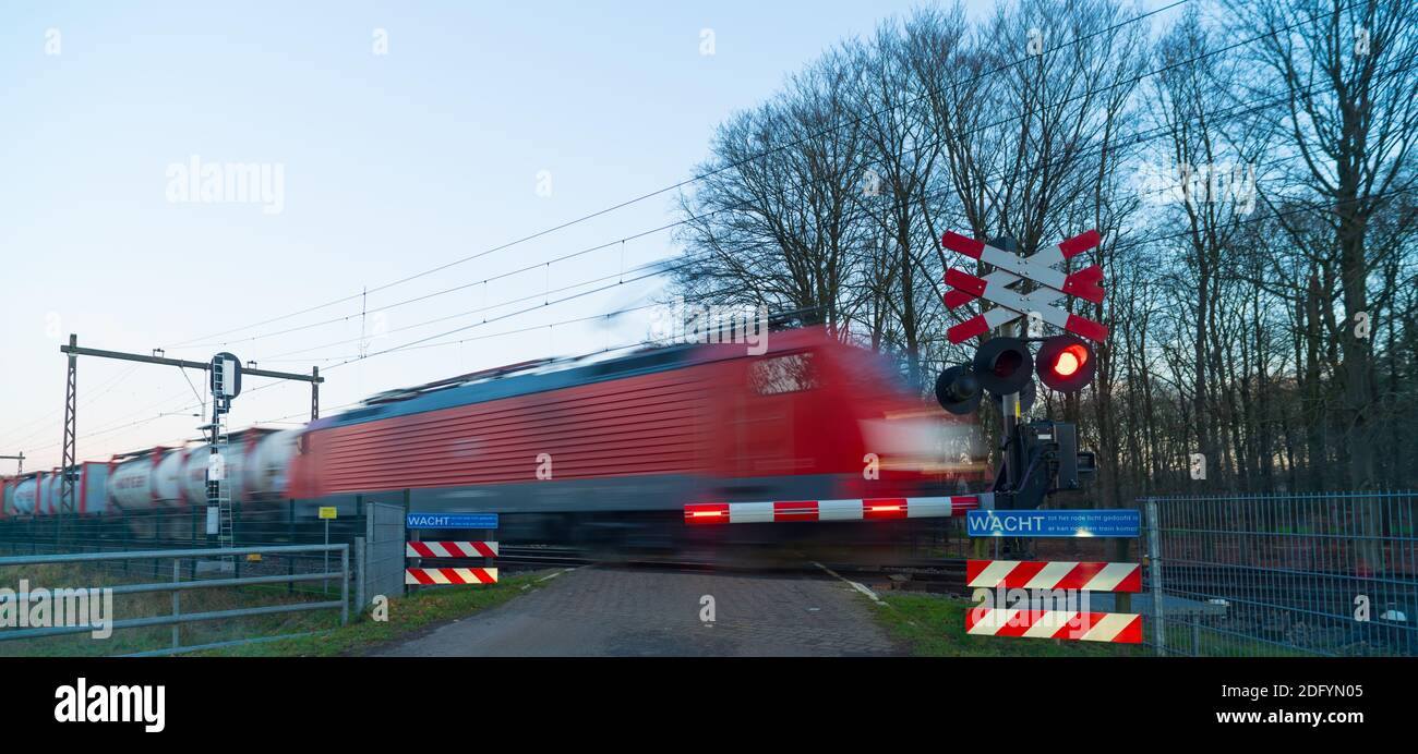 cargo train passing by while waiting for the warning lights Stock Photo ...