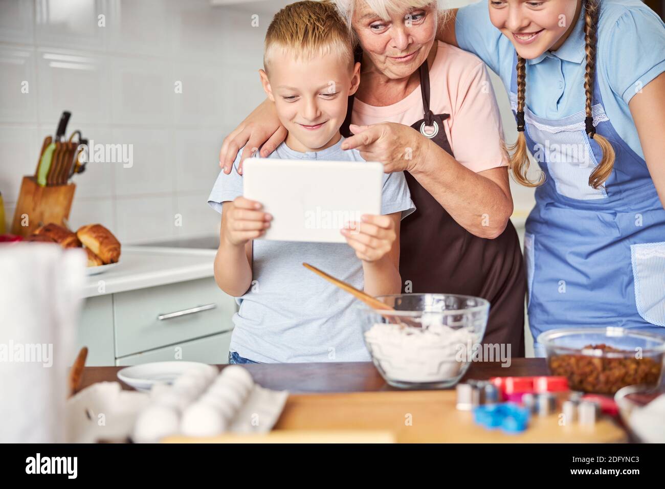 Younger generation passing on technology skills to Grandma Stock Photo ...