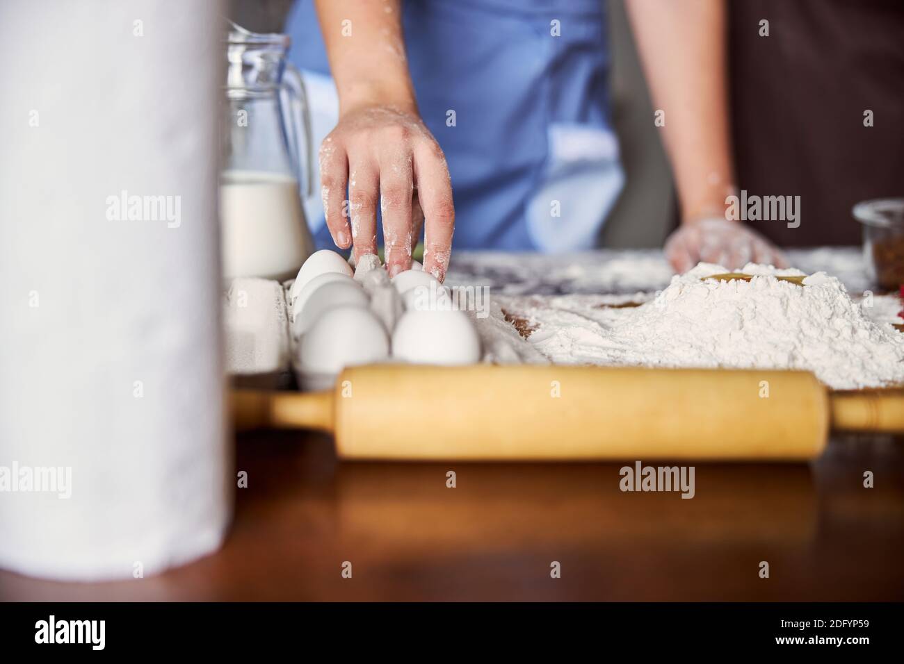 Cook hand taking an egg from a box Stock Photo - Alamy