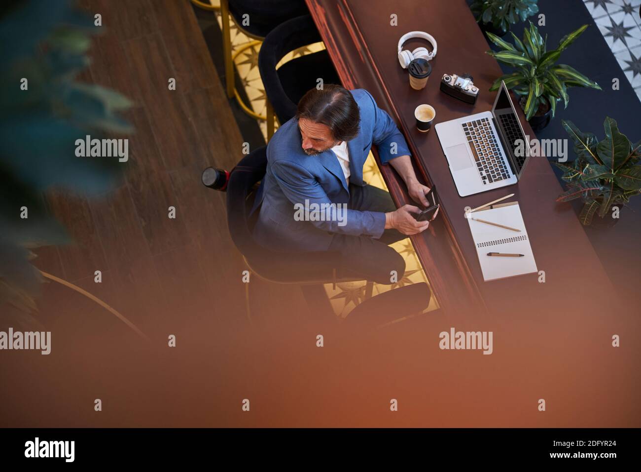 Busy brunette man getting distracted from his work Stock Photo - Alamy