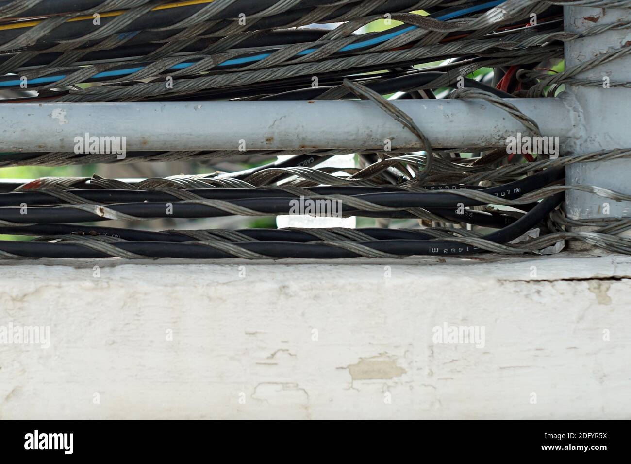 A vintage comminication cable wiring on a cross walk bridge of a road ...