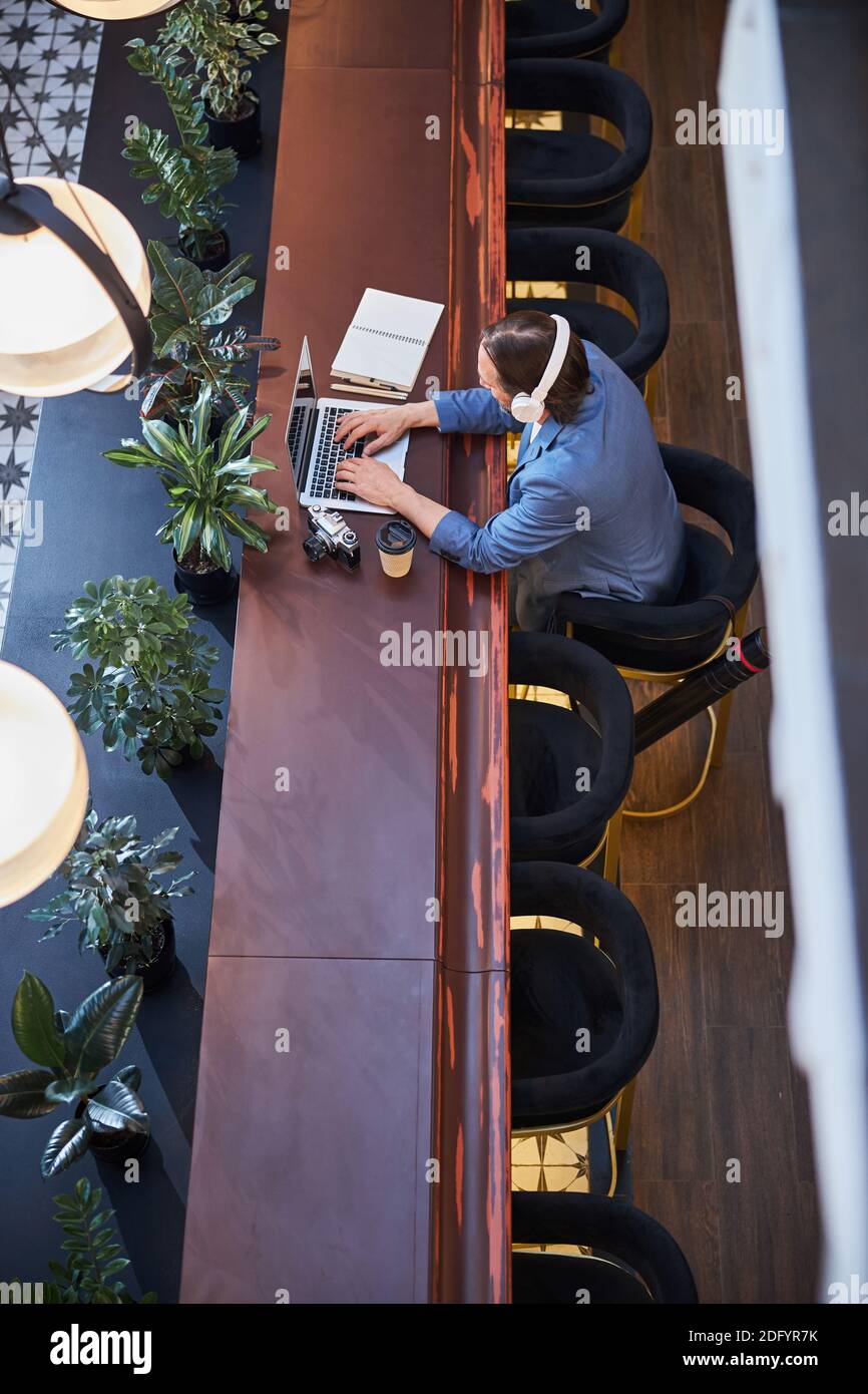 Alone gentleman completing work tasks online at hotel Stock Photo - Alamy