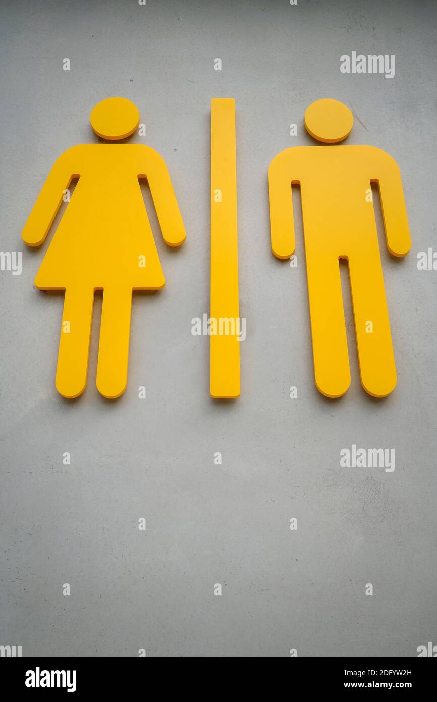 Yellow side by side woman and man symbols of public toilet restroom ...