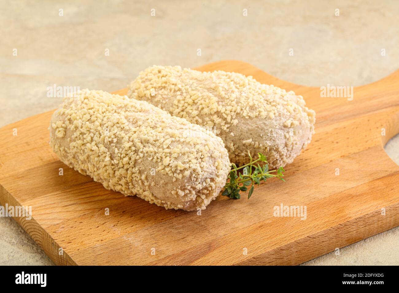 Raw breaded chicken cutlet for roast Stock Photo - Alamy