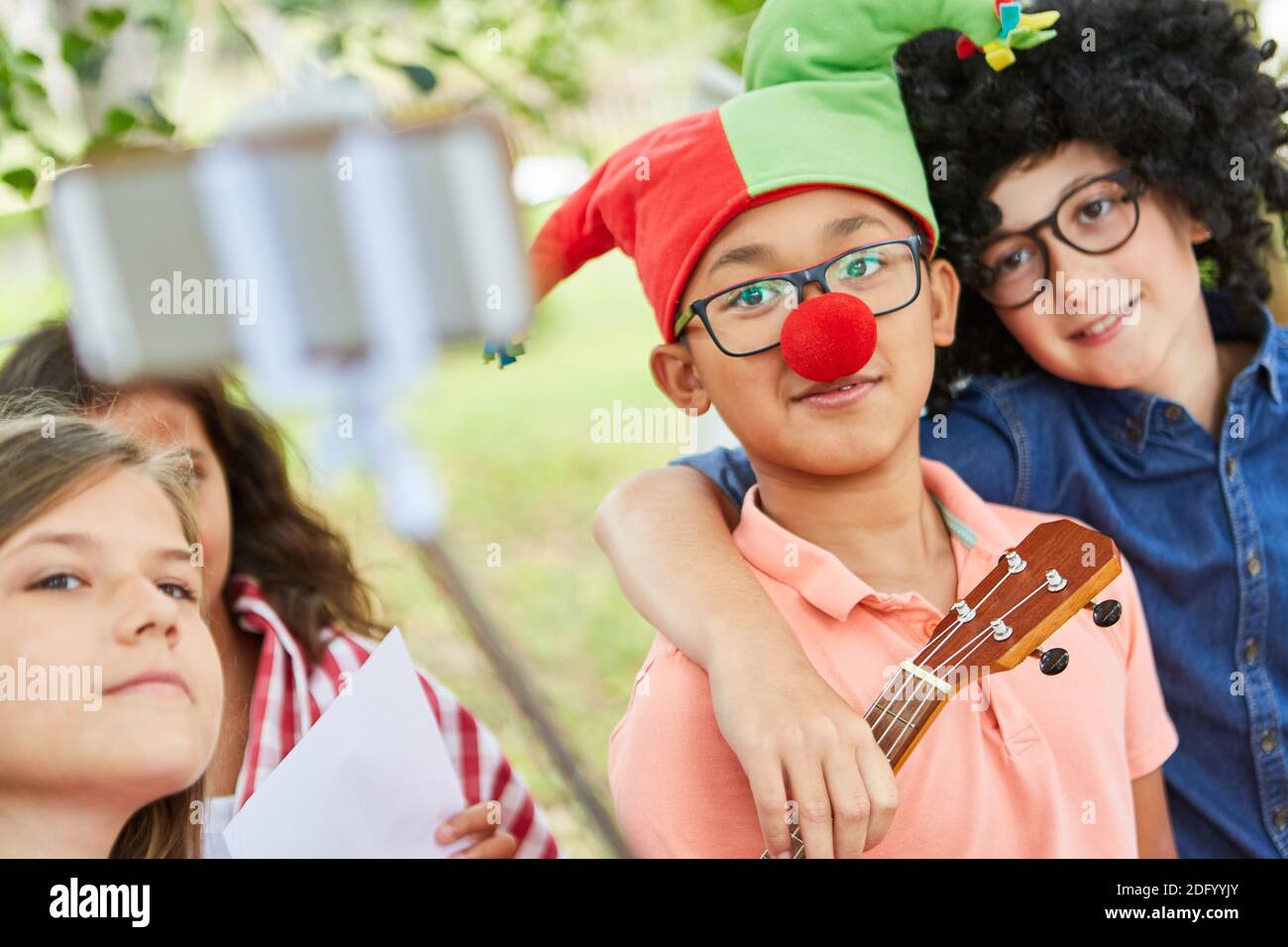 Children take a selfie at the talent show in funny disguise at the ...