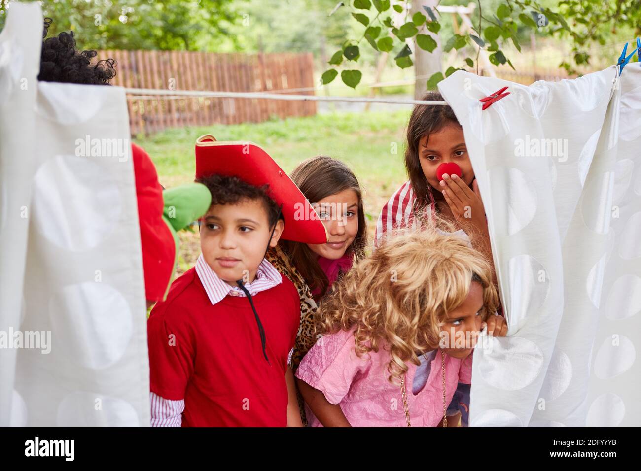 Children in disguise behind the curtain wait for the performance on the ...