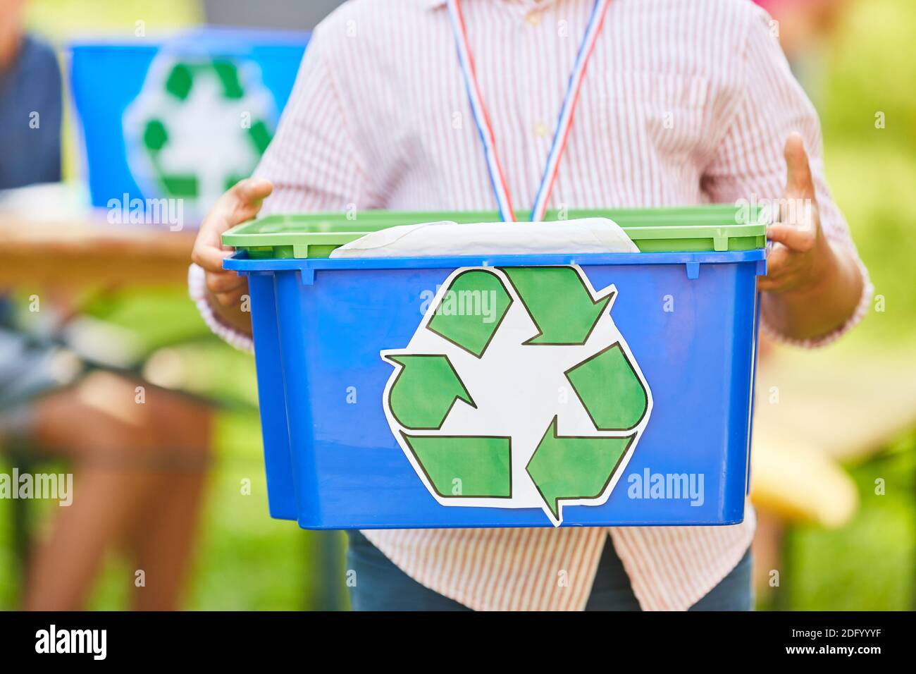 Child holds box with recycling symbol in a project for environmental ...