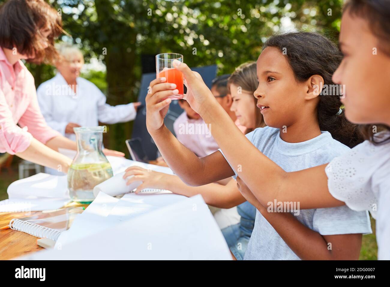 Children make experiments with reagents in the summer course at the ...