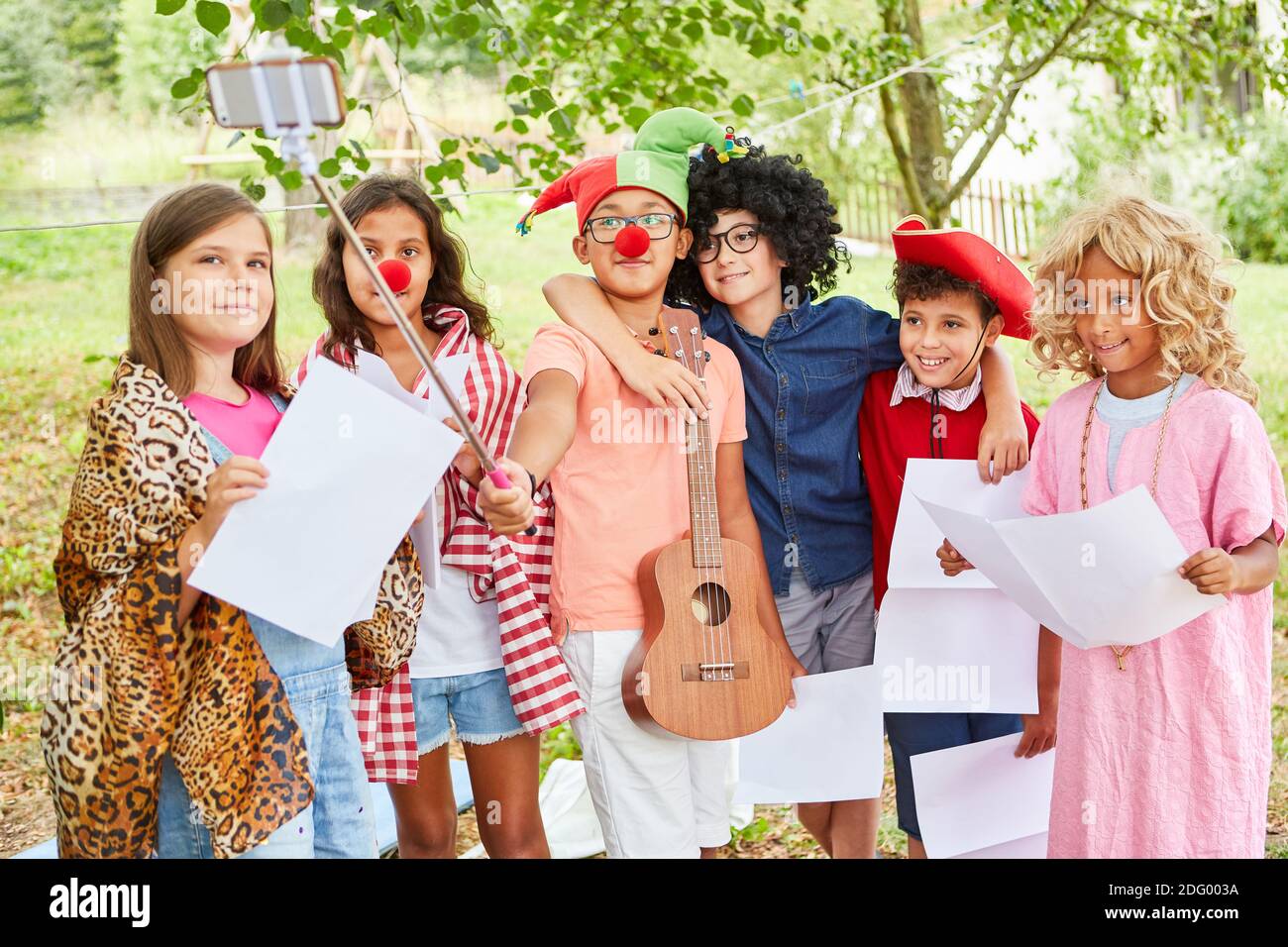 Children in funny disguise make selfie with stick at talent show at ...