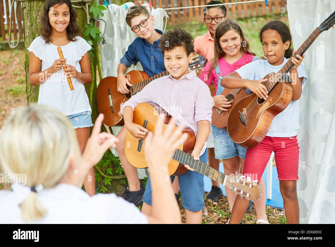The children's band and teacher rehearse together for the talent show ...