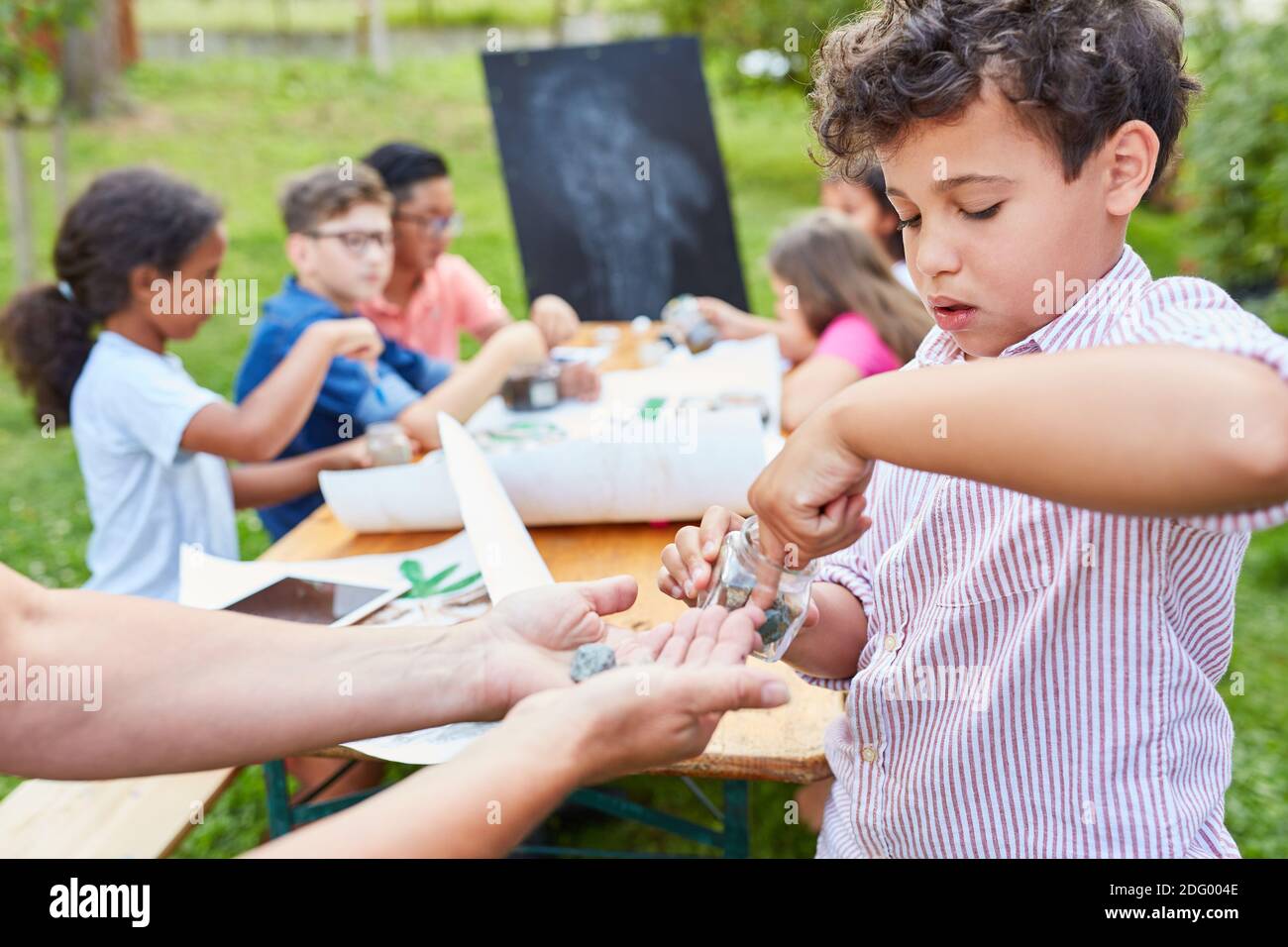 Children in the summer school in the tutoring camp learn about stones ...