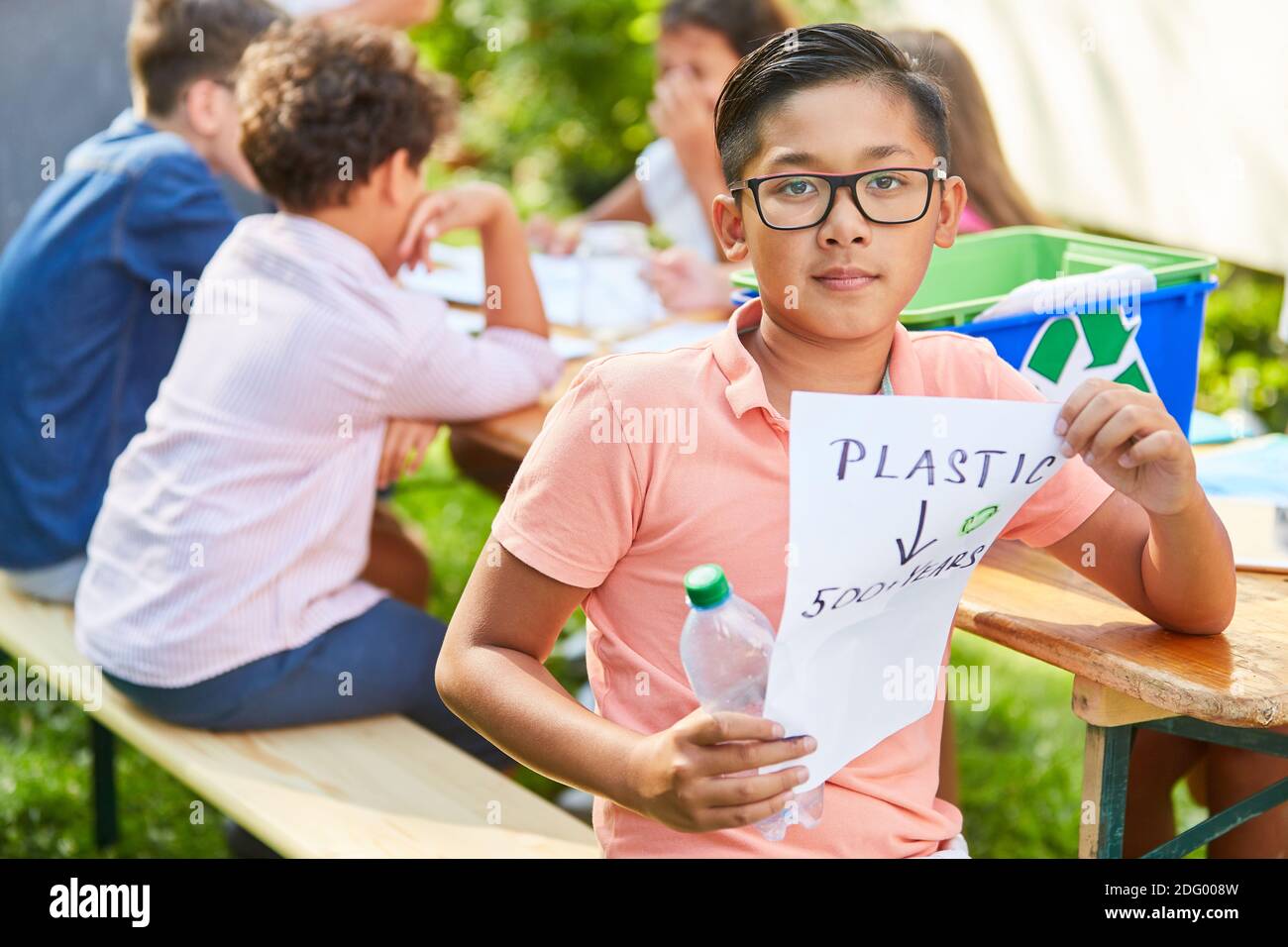 Child as a volunteer environmentalist in a recycling project at the ...