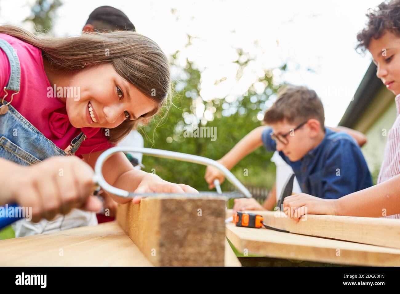 Children work and do handicrafts with wood in the craftsman's workshop ...