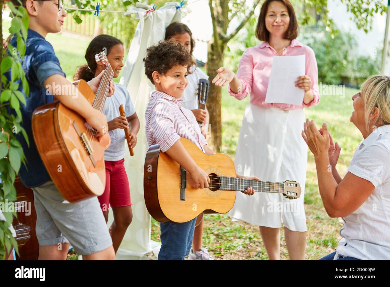 Children group at the talent show performance with guitars in the ...