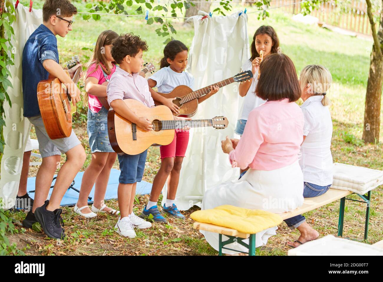 Group of children as a band with guitars at the talent show at the ...