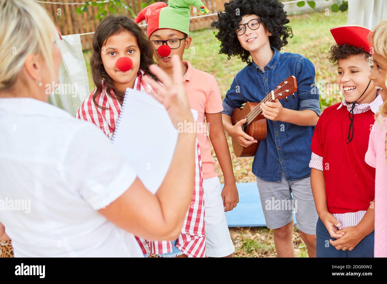 Children in funny disguise plan a talent show together at the summer ...