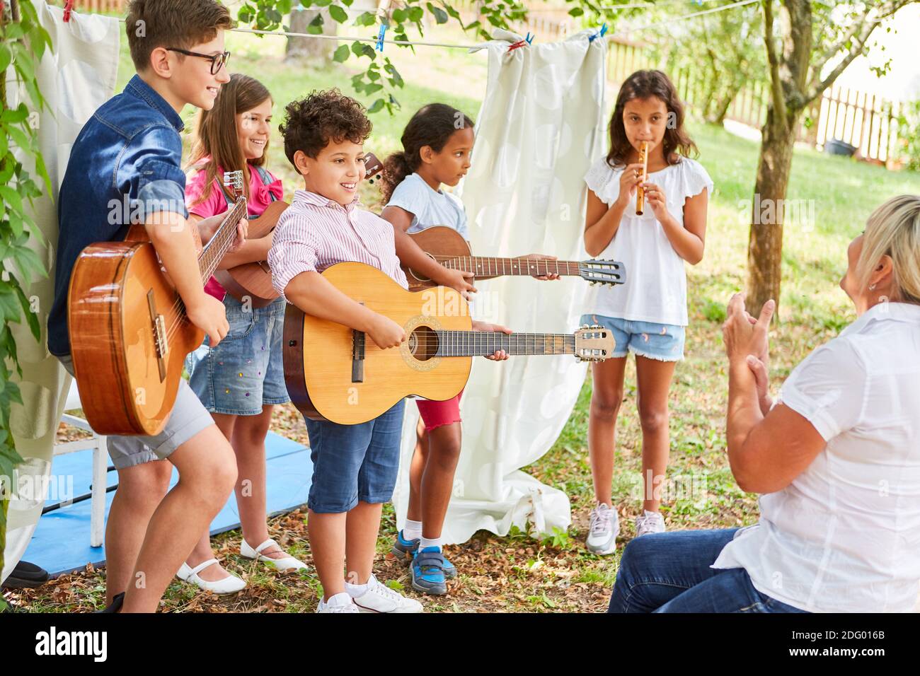 Children group makes music with guitars and flute at the talent show in ...