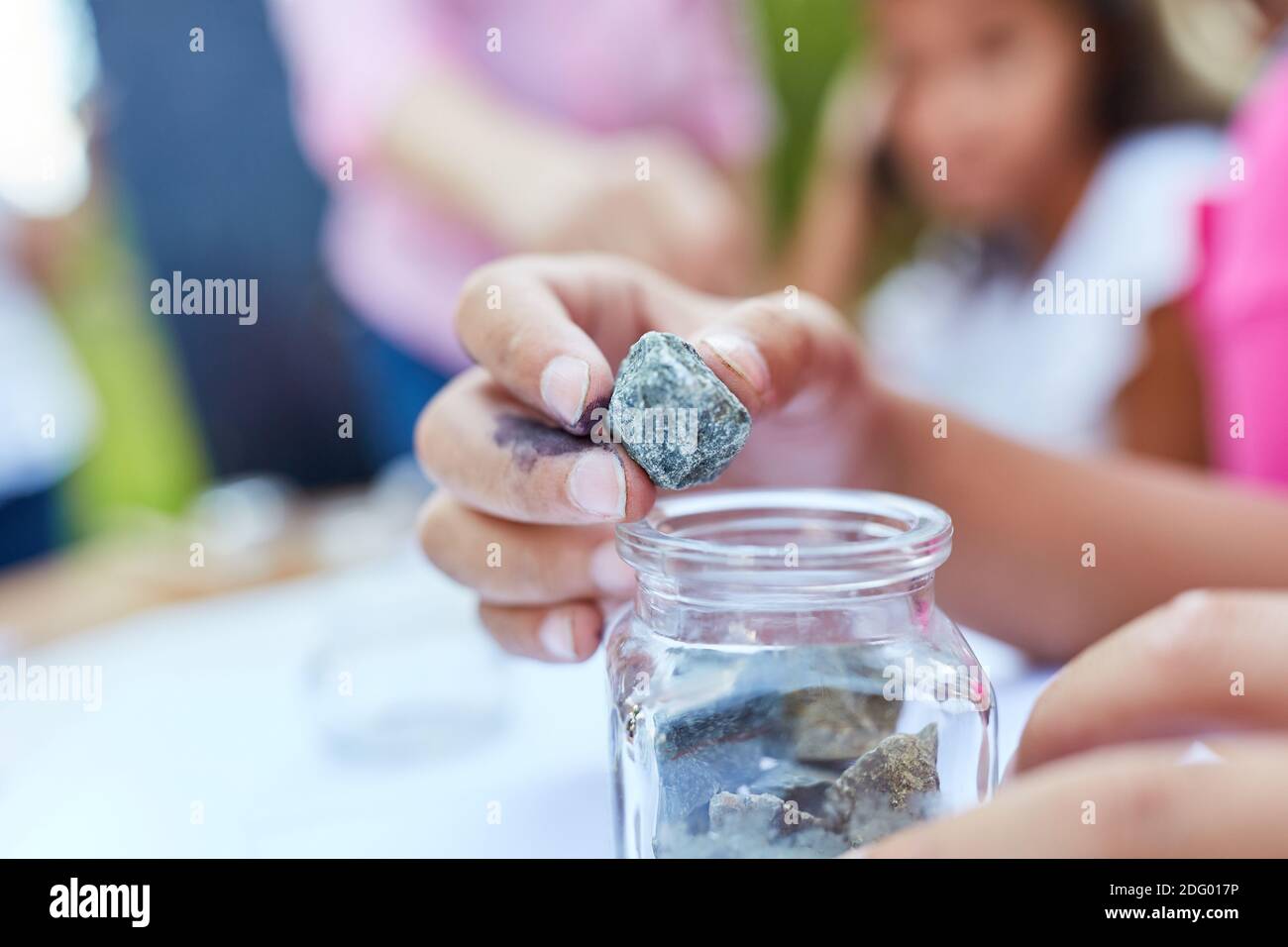 Children examine rocks and minerals in the summer school at the holiday ...