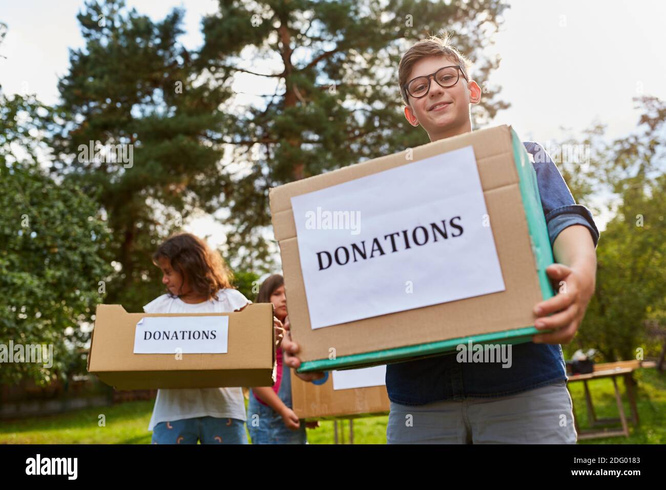 Children as volunteers with donation boxes collecting donations for ...