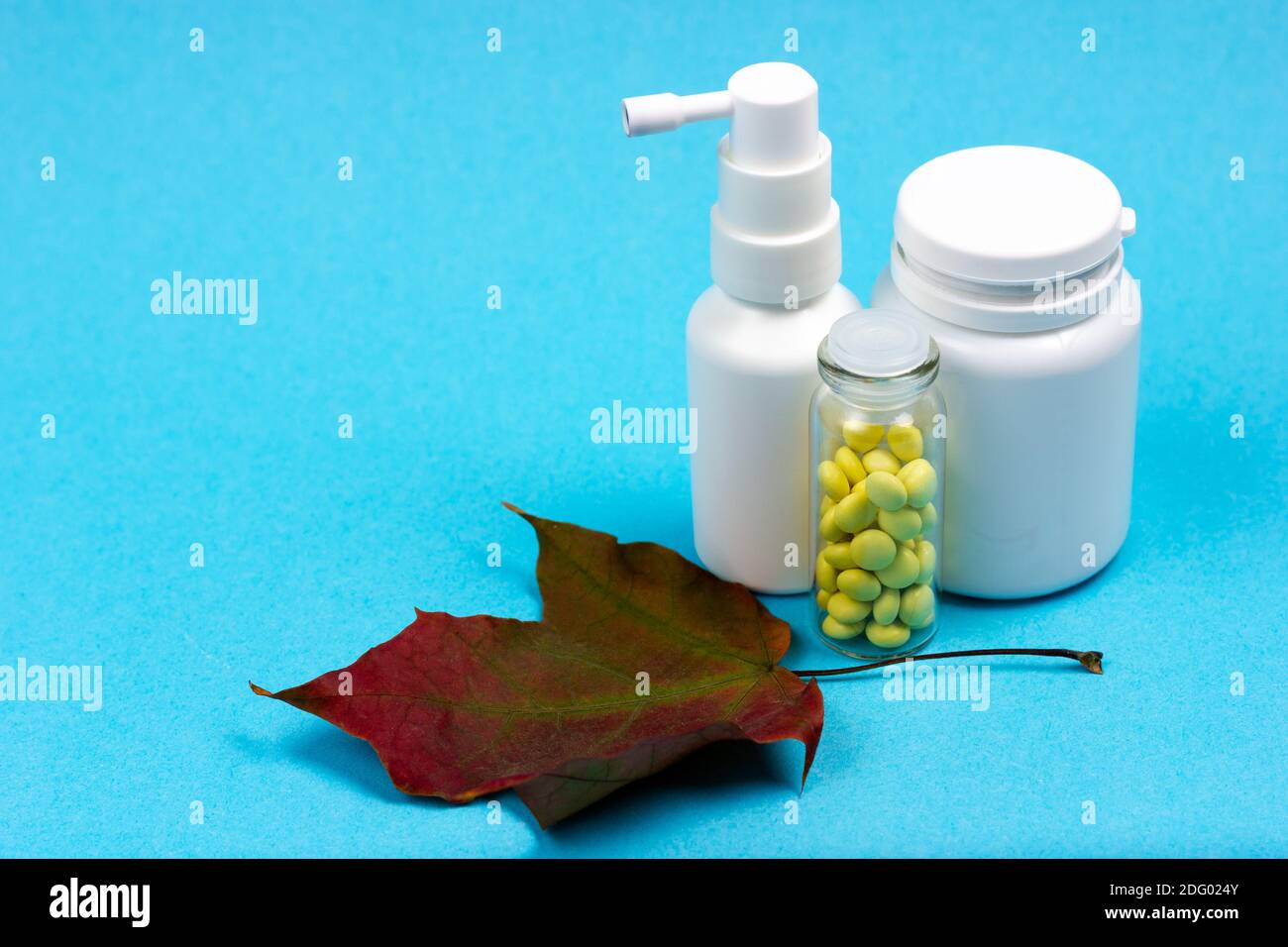 Jars of medical drugs and throat spray on a blue background. Colds, flu ...
