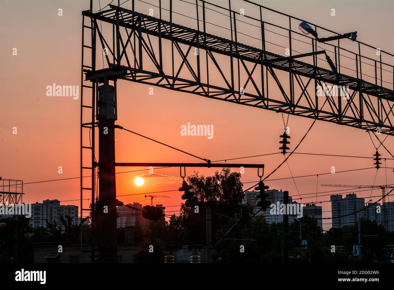 power lines hanging on an iron structure. in the background a city in ...