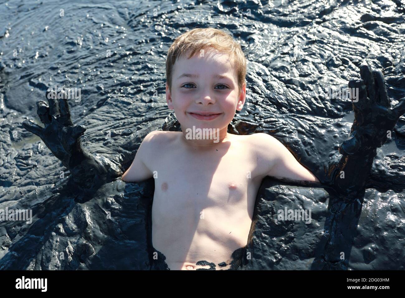 Boy lying in healing mud, Primorsko-Akhtarsk, Russia Stock Photo - Alamy
