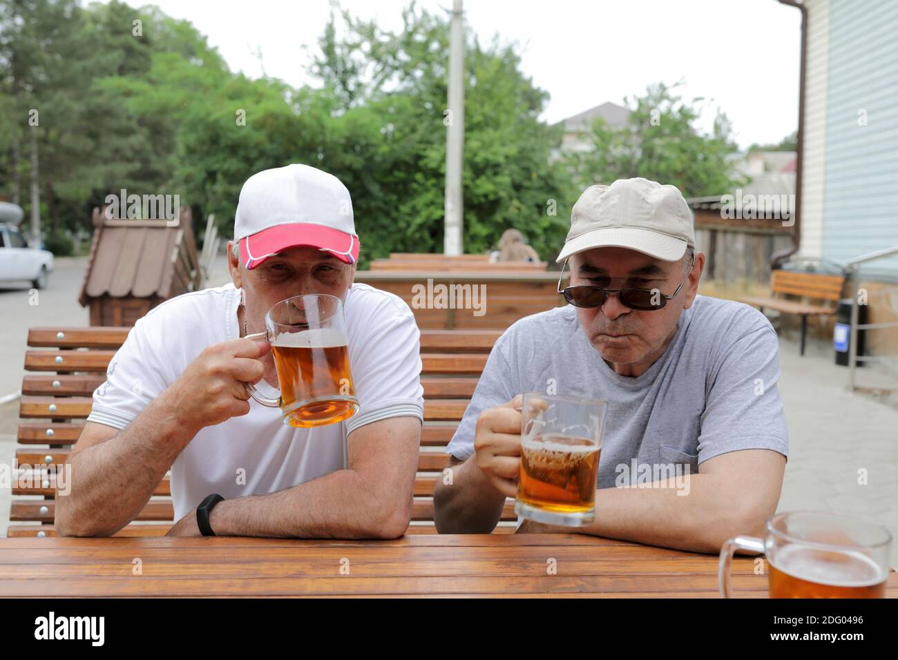 Two senior men drinking beer in outdoor cafe Stock Photo - Alamy