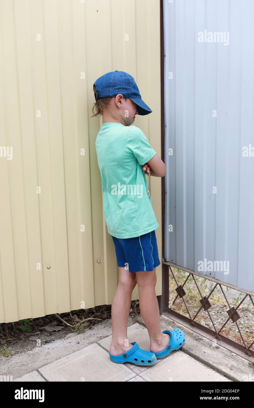 Child crying in the corner at backyrad Stock Photo - Alamy