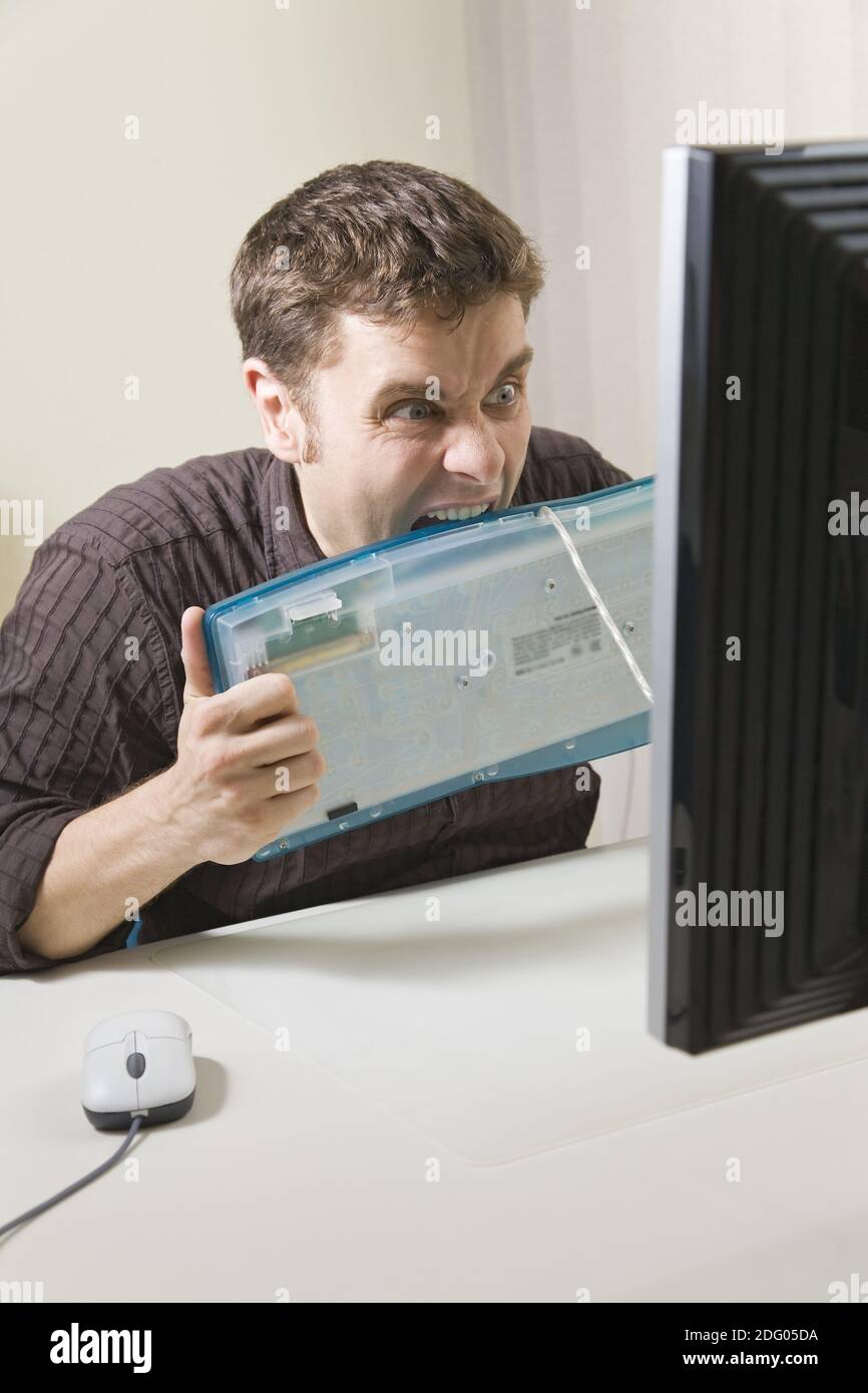 Bite the keyboard in frustration Stock Photo - Alamy
