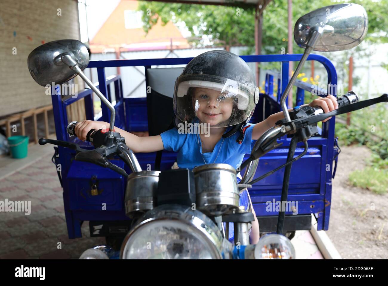 Portrait of a child driving a tricycle Stock Photo - Alamy