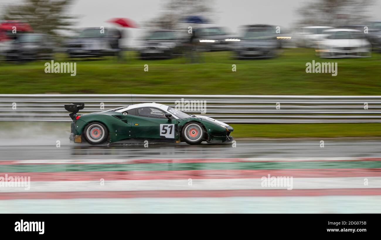 A panning shot of a racing car as it circuits a track Stock Photo - Alamy